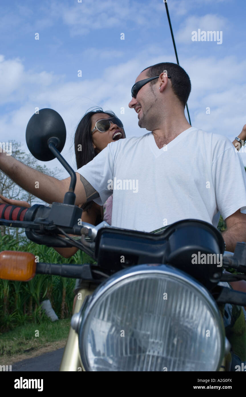 couple talking on motorcycle on roadside Stock Photo - Alamy