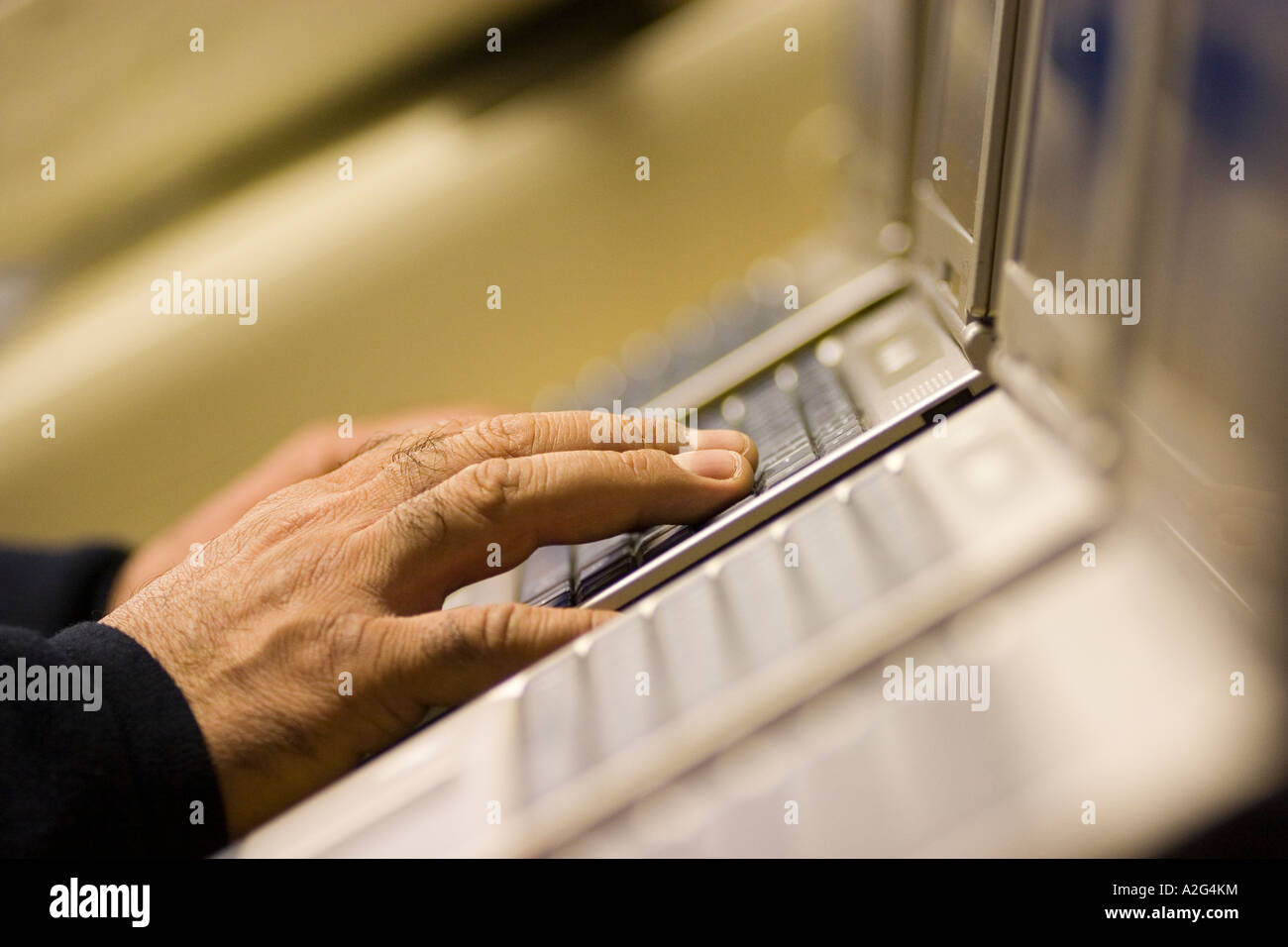 Laptops in a line with one being worked on Stock Photo - Alamy