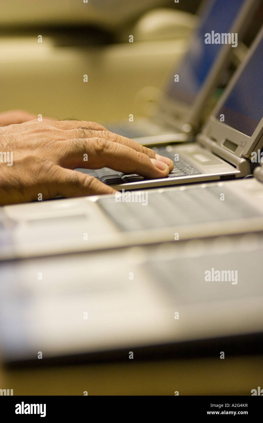 Laptops in a line with one being worked on Stock Photo - Alamy