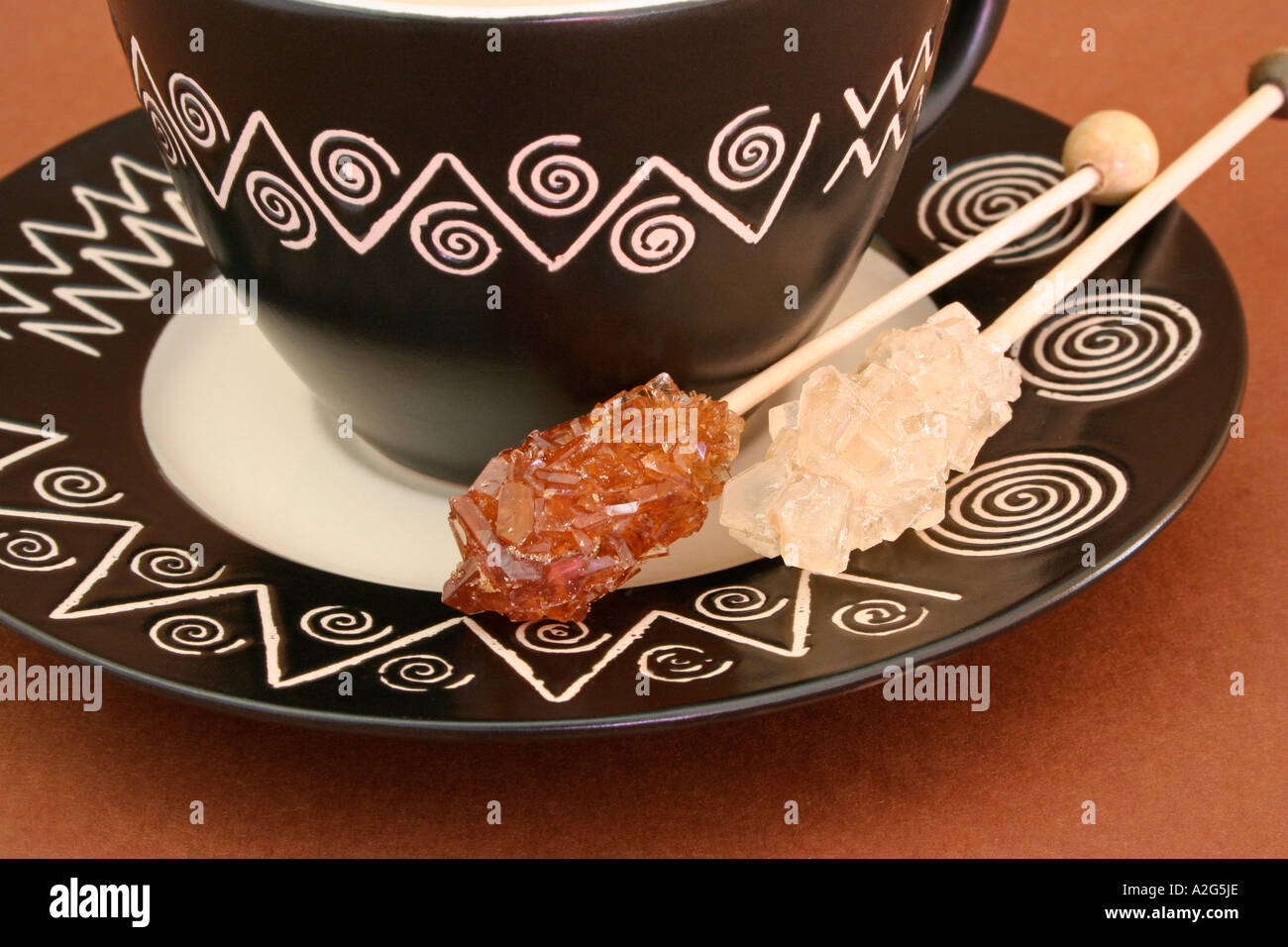 Tea cup with african design and sugar sticks Stock Photo - Alamy