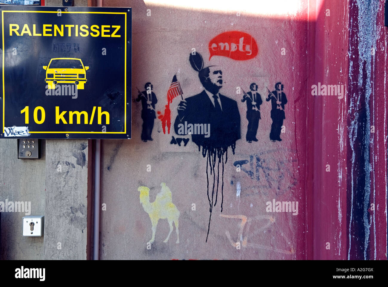 327 a detail of graffiti wall with stencils of bush a camel and a speed ...