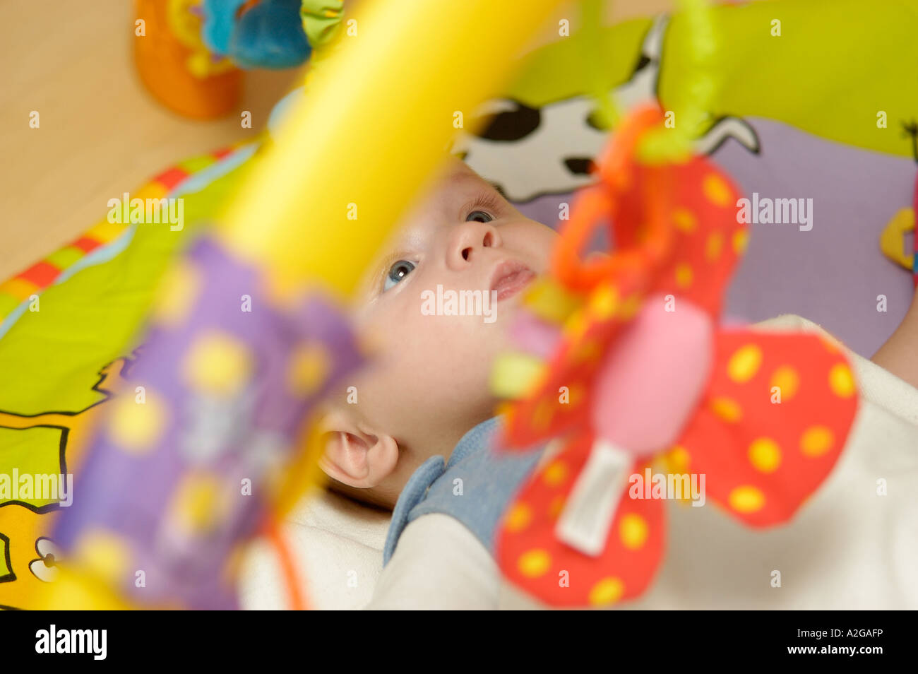 Baby Boy lying on play mat Stock Photo - Alamy