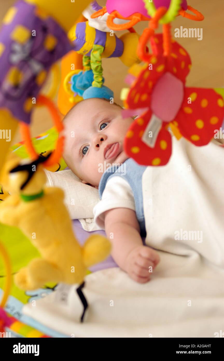 Baby Boy lying on play mat Stock Photo - Alamy