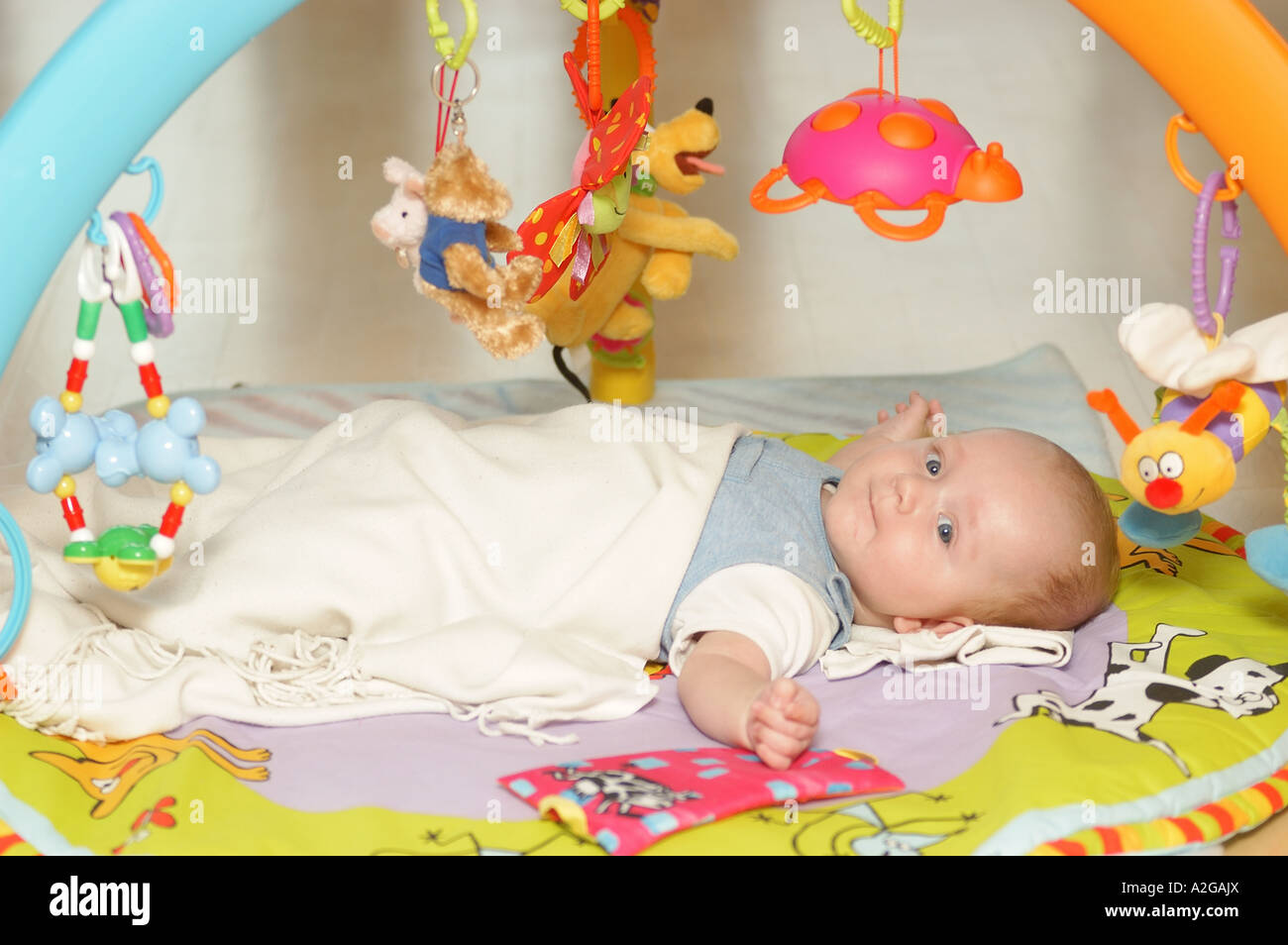 Baby child Boy lying on play mat Stock Photo - Alamy