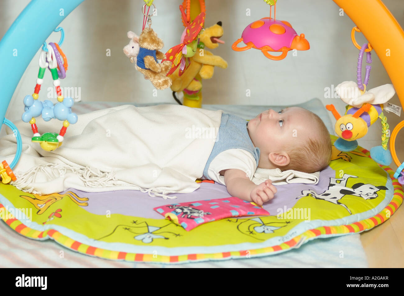 Baby Boy lying on play mat Stock Photo - Alamy