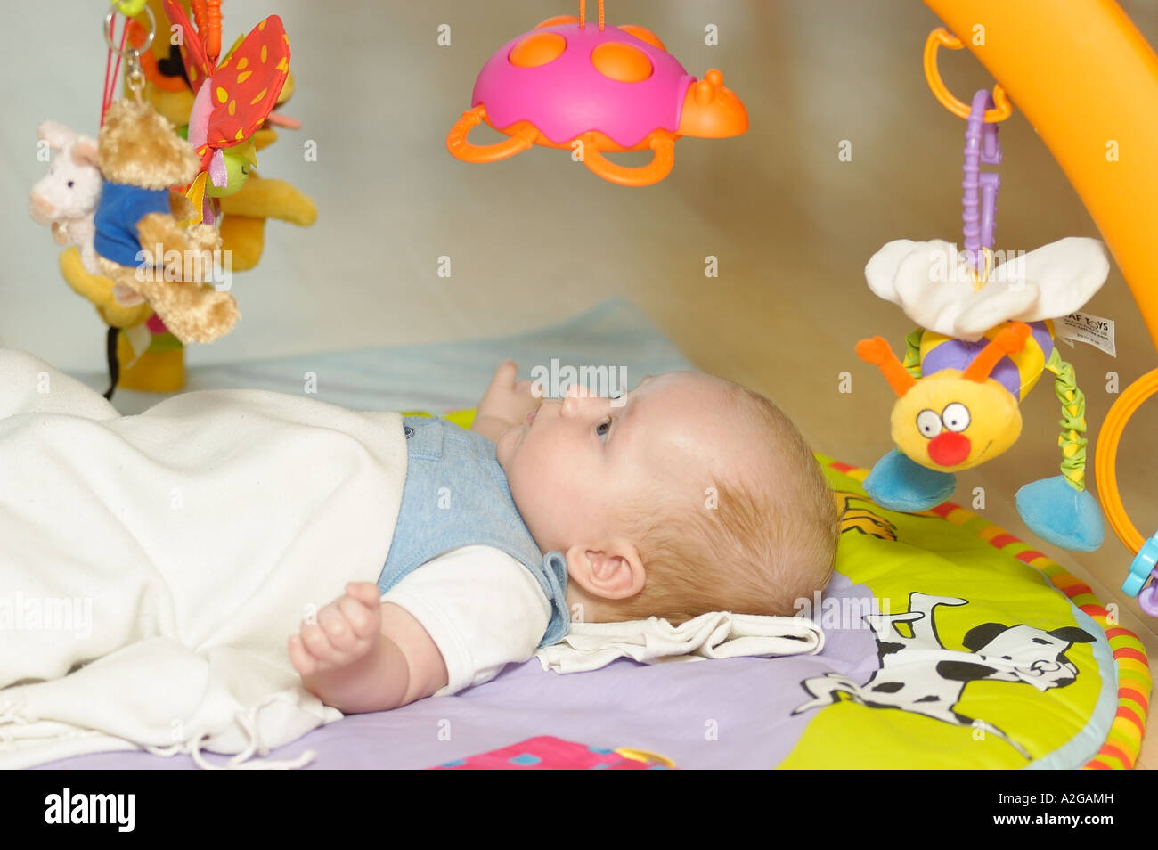 Baby Boy lying on play mat Stock Photo - Alamy