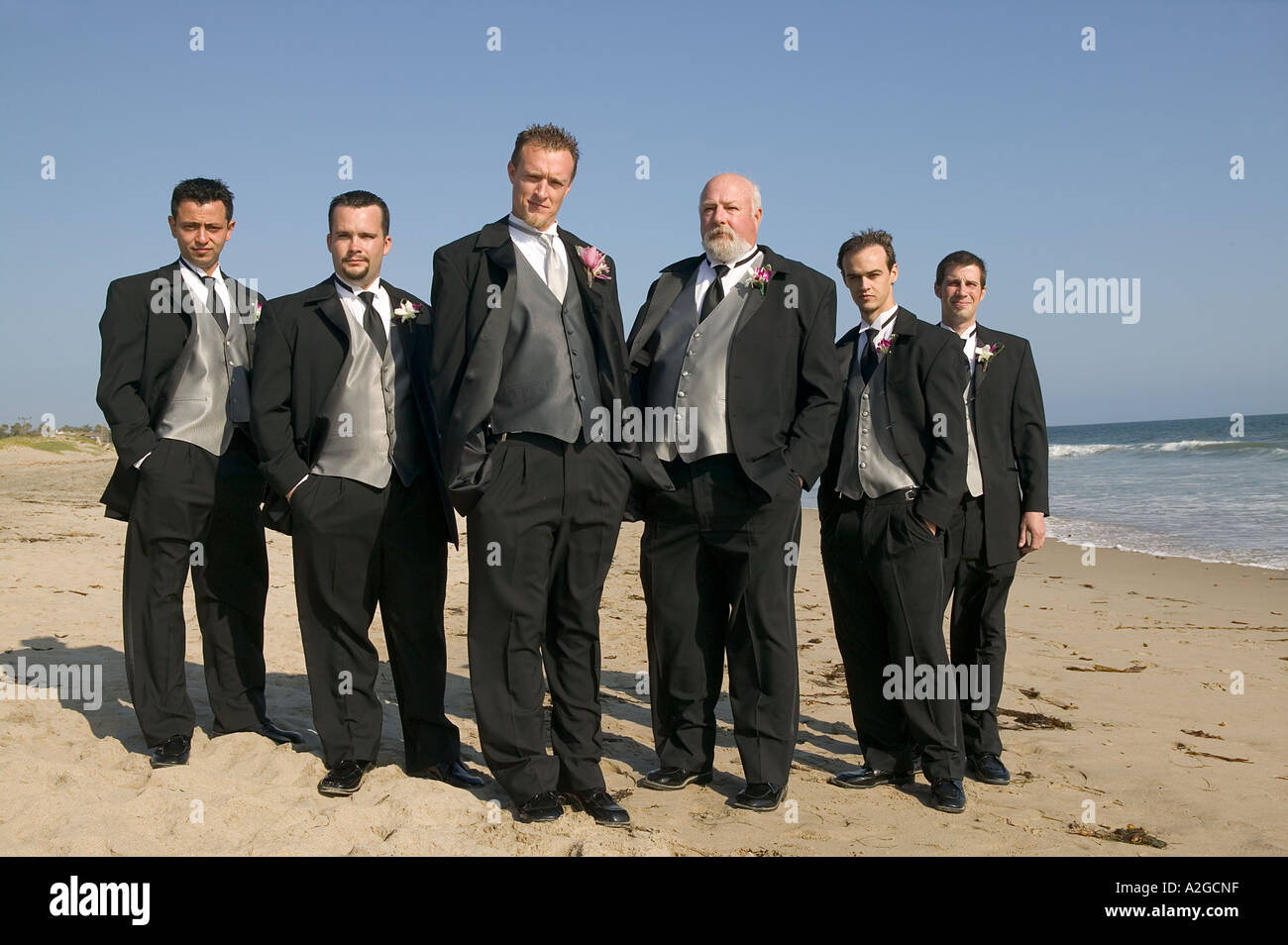 Portrait of Groom with his Father and groomsmen at wedding in Malibu ...