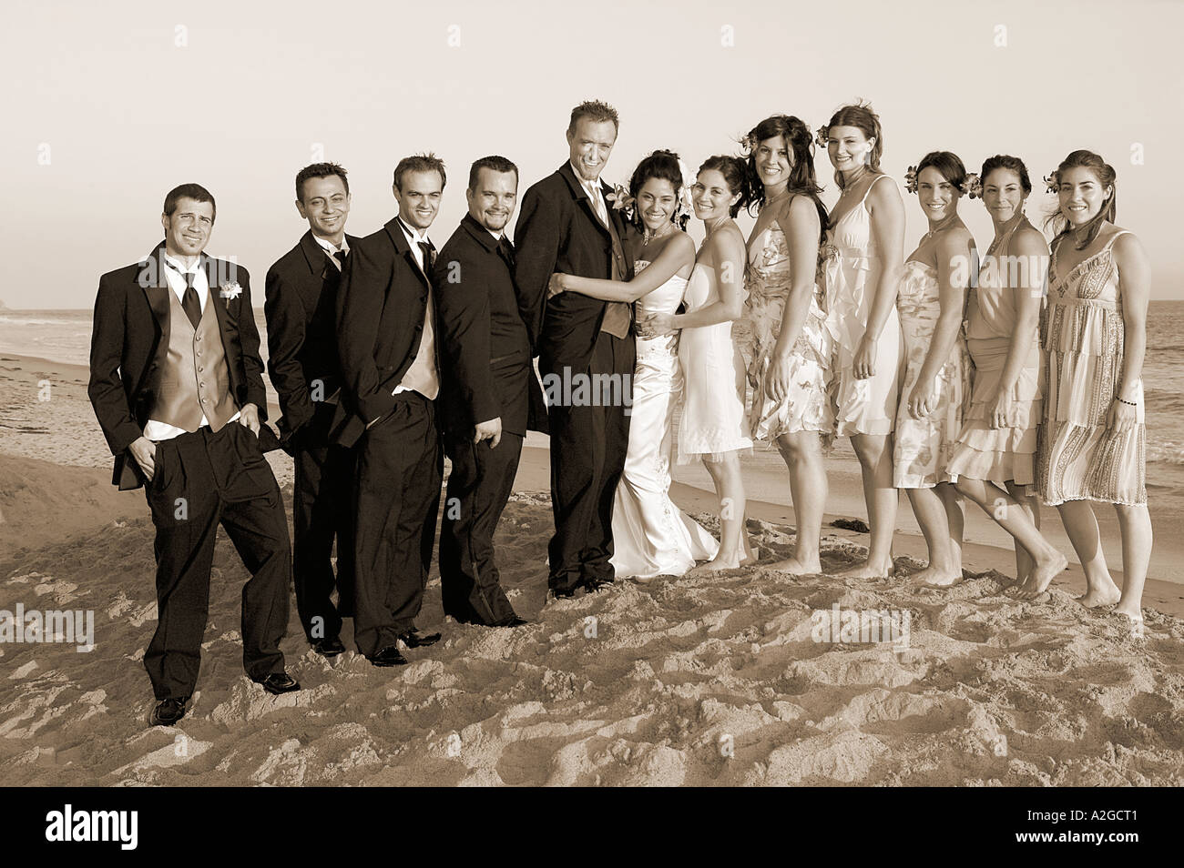 Sepia toned portrait of bride and groom with their bridesmaids and ...