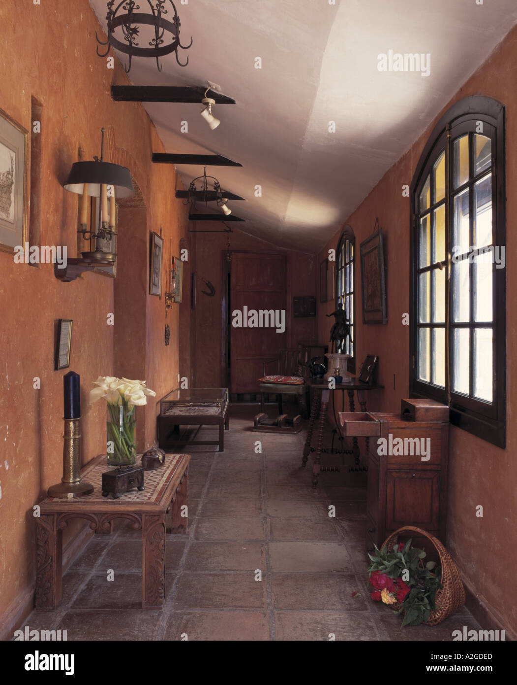 Glass topped table in terracotta Spanish country hall with paved ...