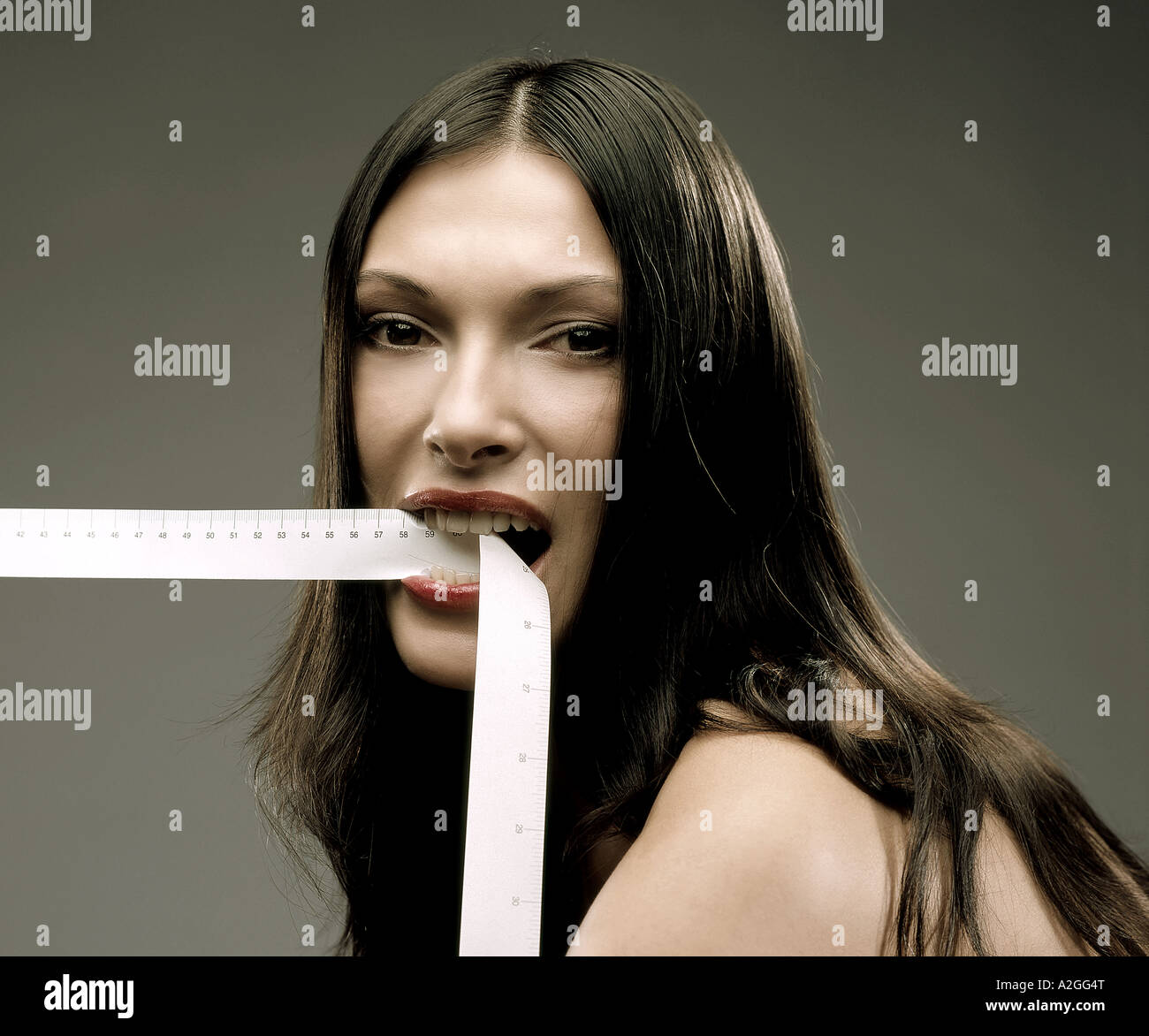 1216664 indoor studio young woman 25 30 brunette long hair tape ...