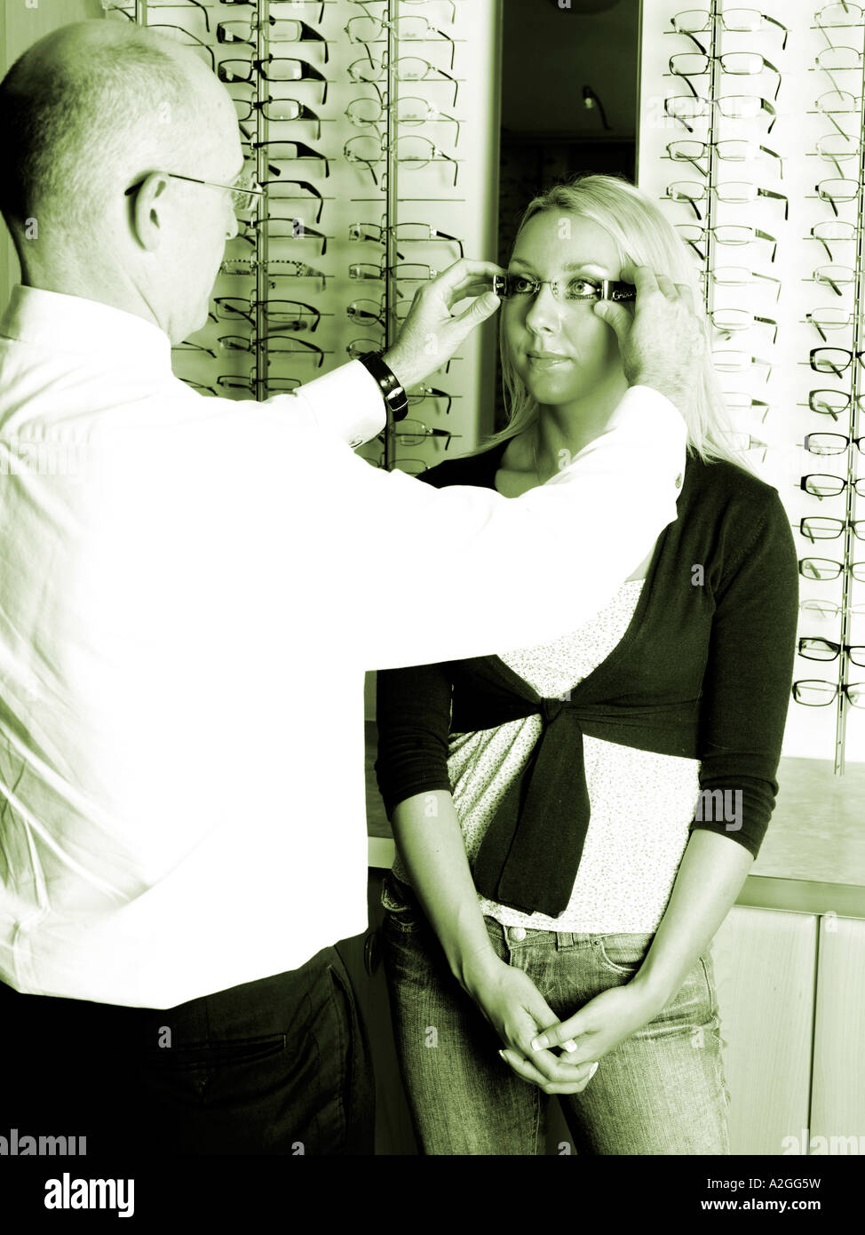 Optician Advising Young Woman Models Released Stock Photo - Alamy