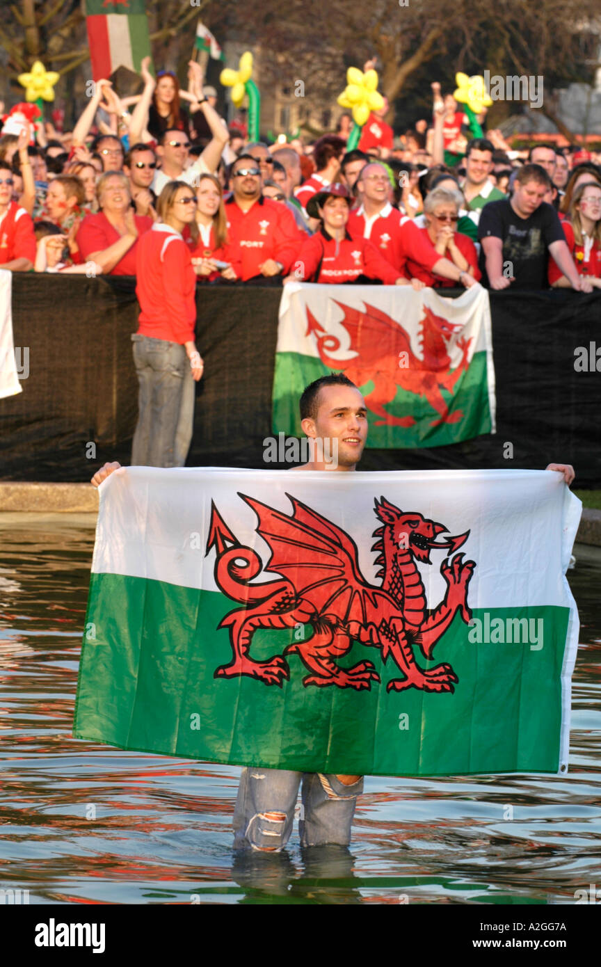 Wales rugby fans with Welsh red dragon flags celebrate after an ...