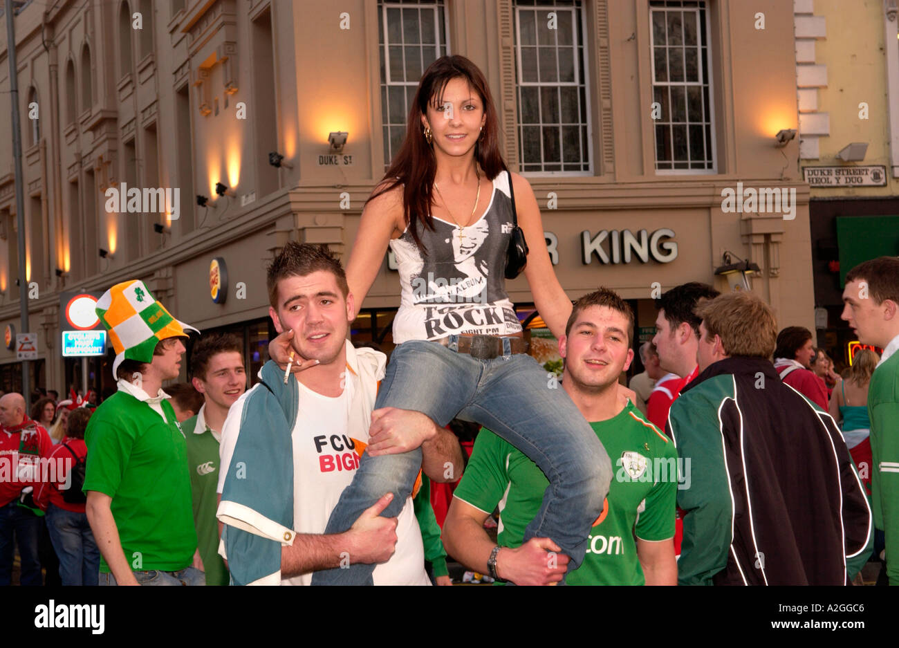 Rugby fans with young woman on their shoulders celebrate in Cardiff ...
