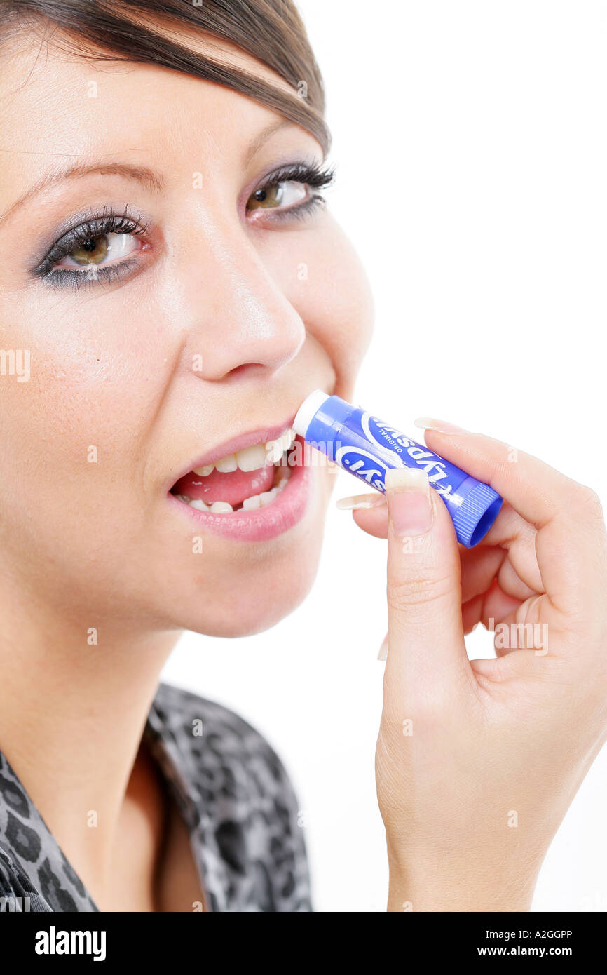 Young Woman Using Lip Balm Model Released Stock Photo - Alamy