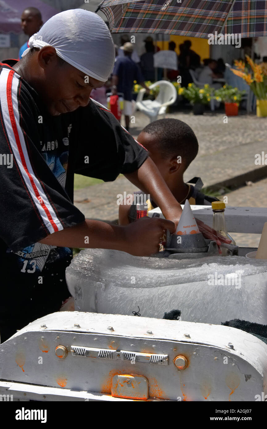 A young black man makes some shaved ice Stock Photo - Alamy