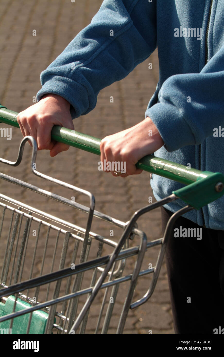 womans hands pushing shopping trolley Stock Photo - Alamy