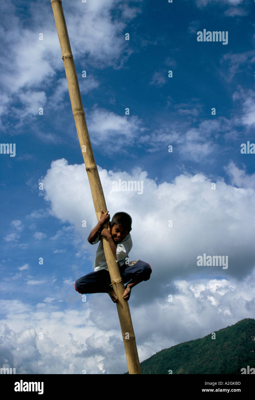 Boy climbing bamboo pole Nepal Stock Photo - Alamy