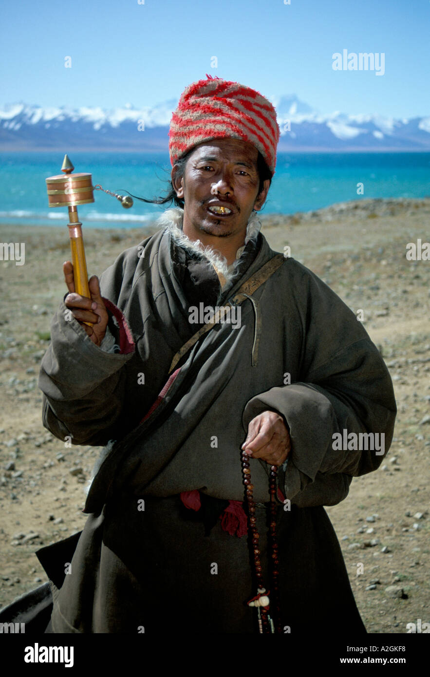 Tibeten nomad spinning prayerwheel Nam Tso lake Tibet Stock Photo - Alamy