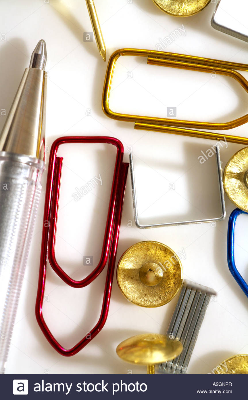 Paperclips, drawing pins, staples and a pen Stock Photo - Alamy