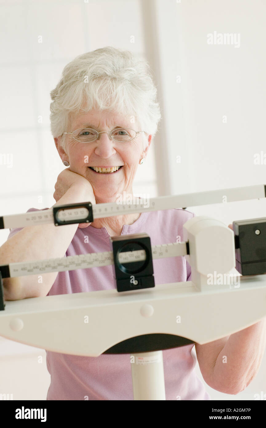 Senior woman weighing self on scale Stock Photo - Alamy Senior woman weighing self on scale Stock Photo - Alamy
