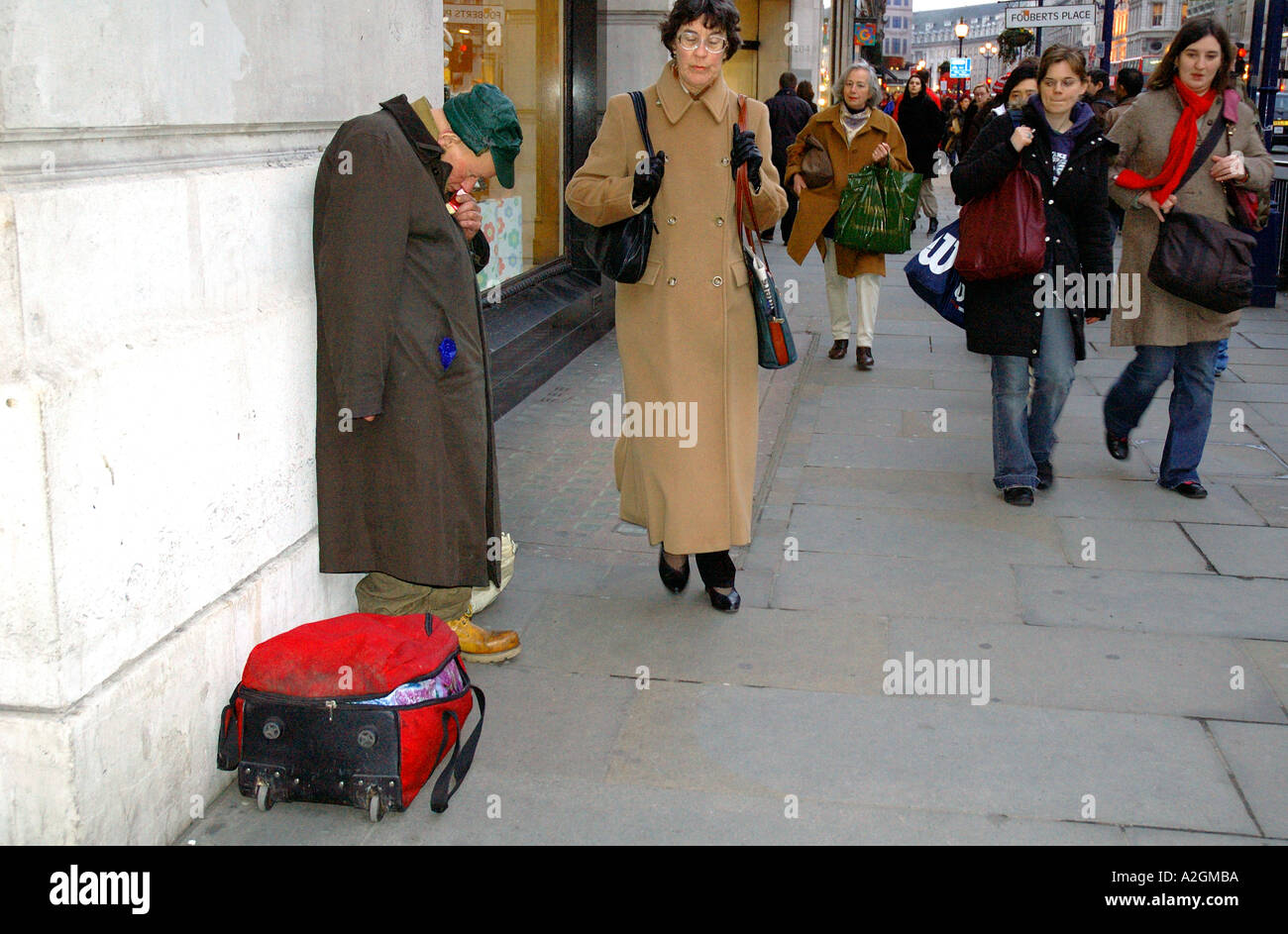 Homeless man playing harmonica begging on Regents Street central London ...
