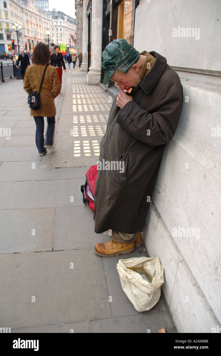 Homeless man playing harmonica begging on Regents Street central London ...