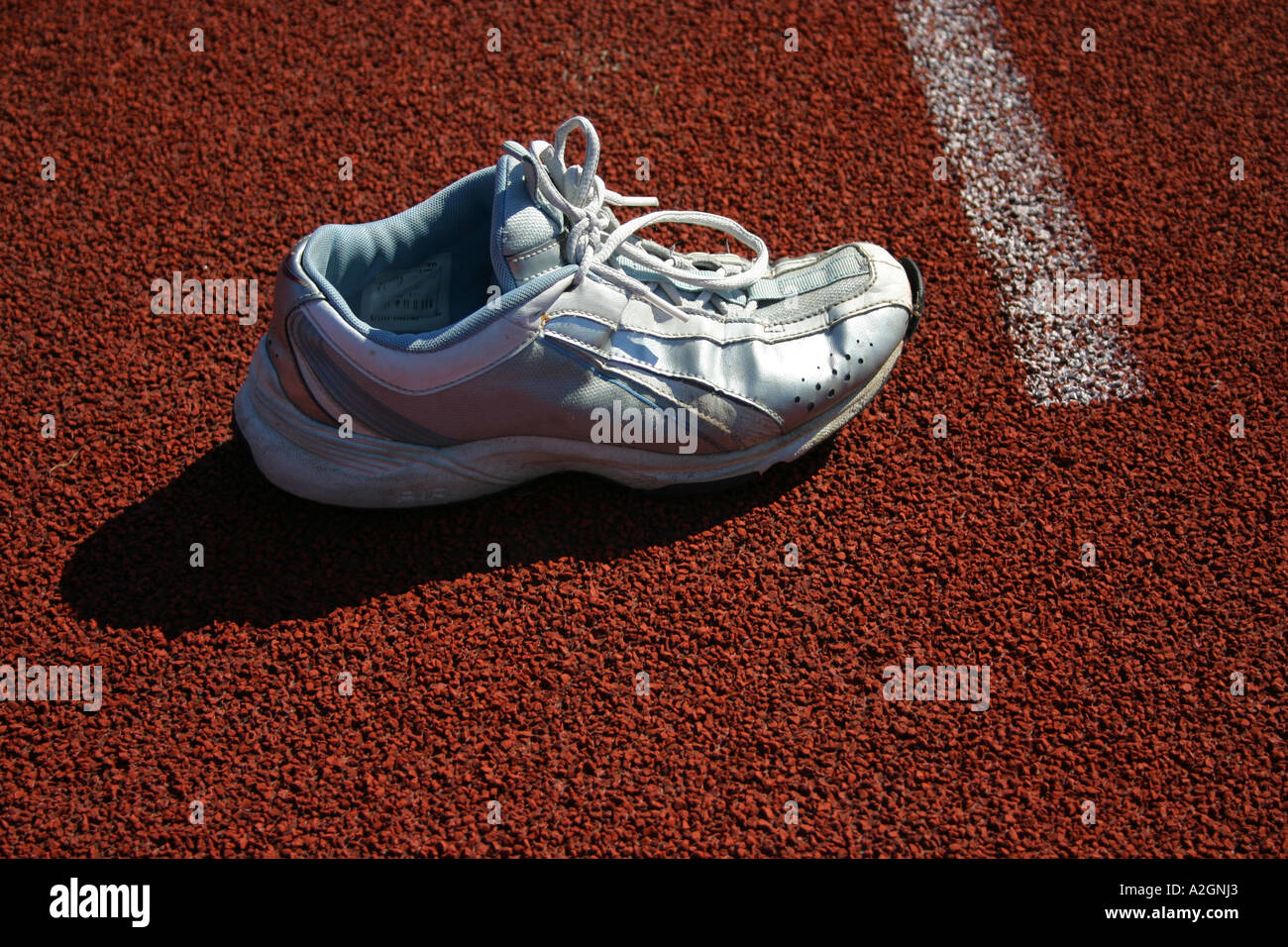 Athletic Shoe on running track Stock Photo - Alamy