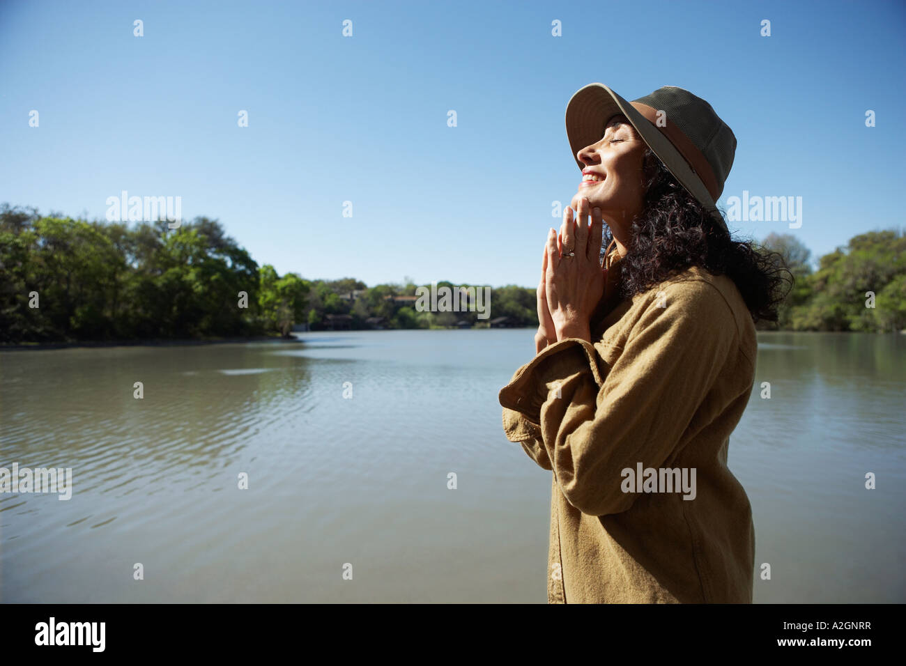 Woman smiling with sun on her face Stock Photo - Alamy