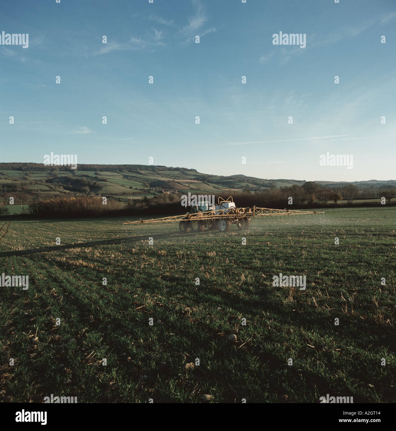 John Deere tractor with Knight trailed sprayer spraying young wheat ...