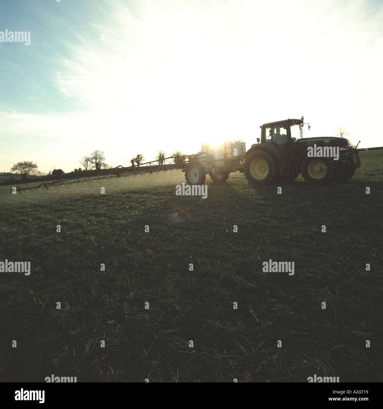 John Deere tractor with Knight trailed sprayer spraying young wheat ...