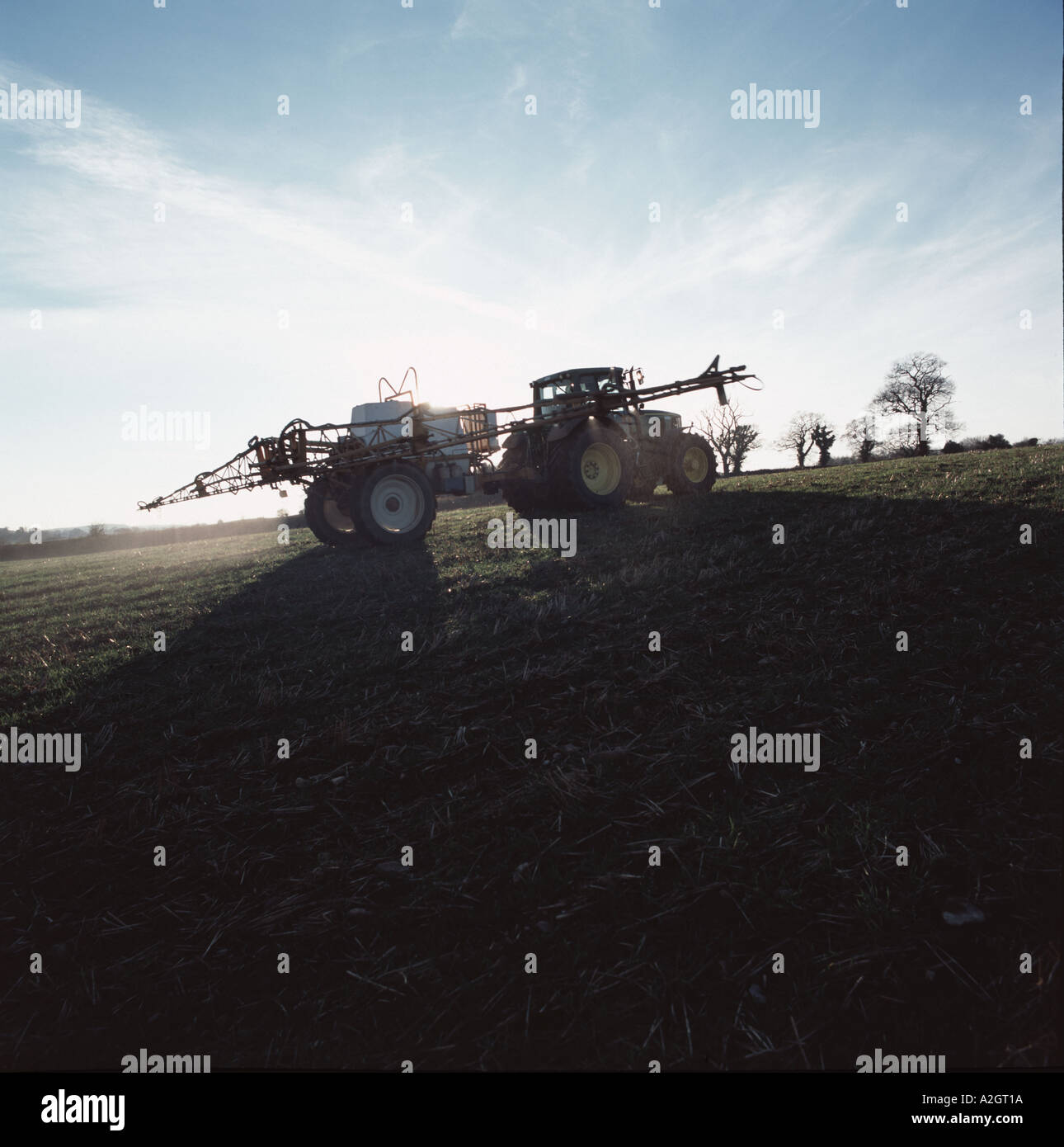 John Deere tractor with Knight trailed sprayer spraying young wheat ...
