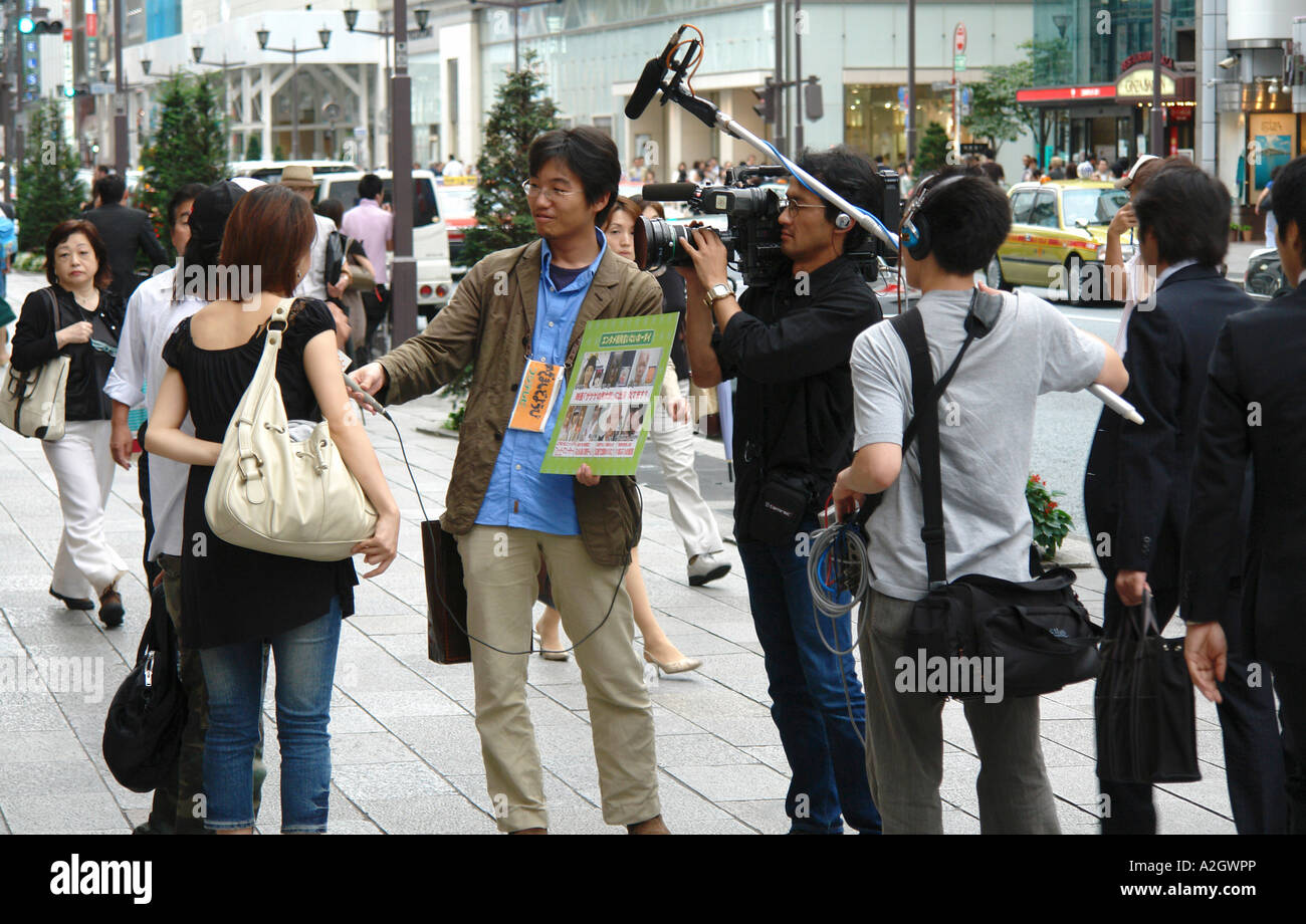Japanese camera crew and interviewer filming on Ginza, Tokyo Japan ...