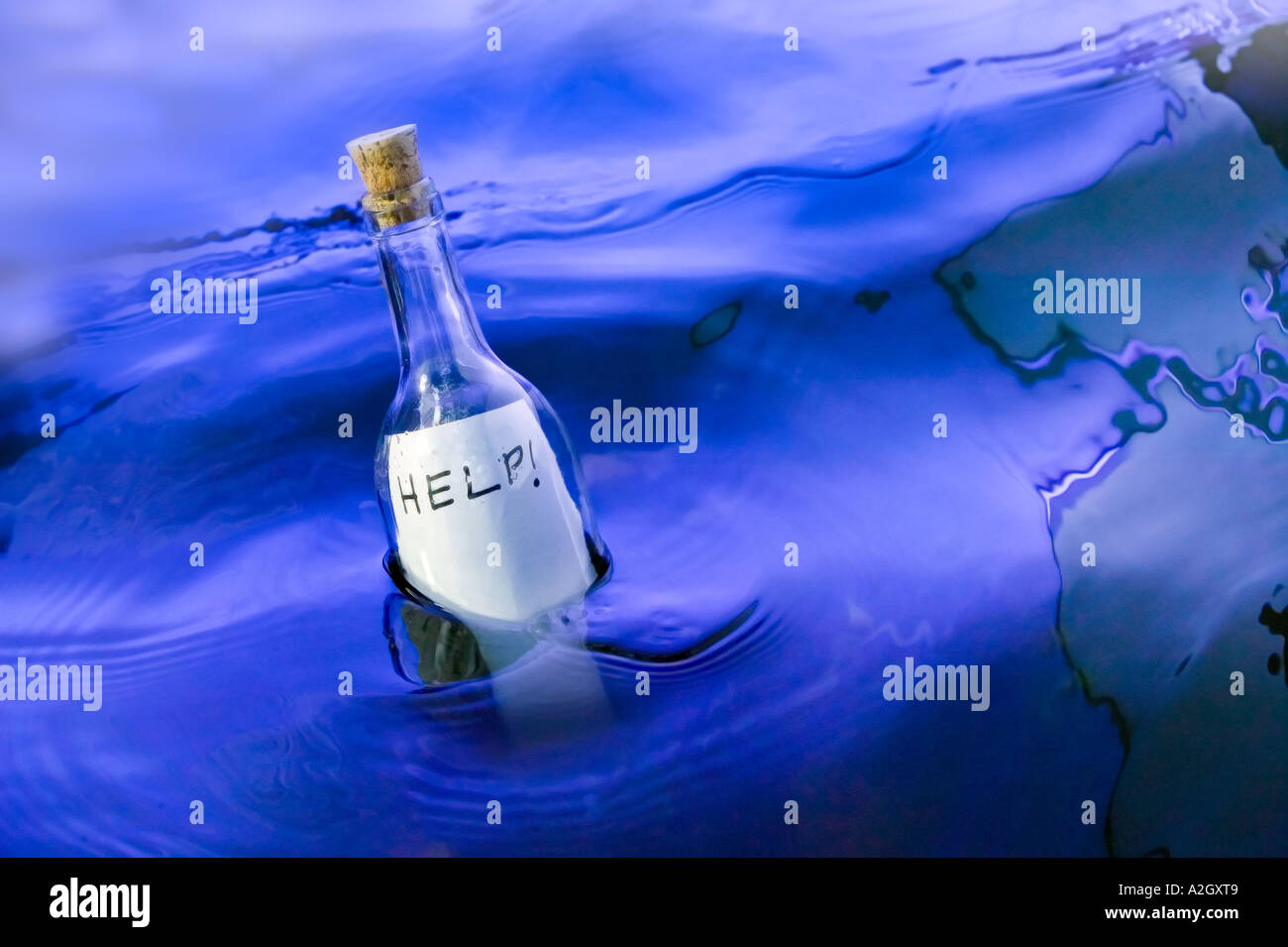 message in a floating bottle saying 'help' Stock Photo - Alamy