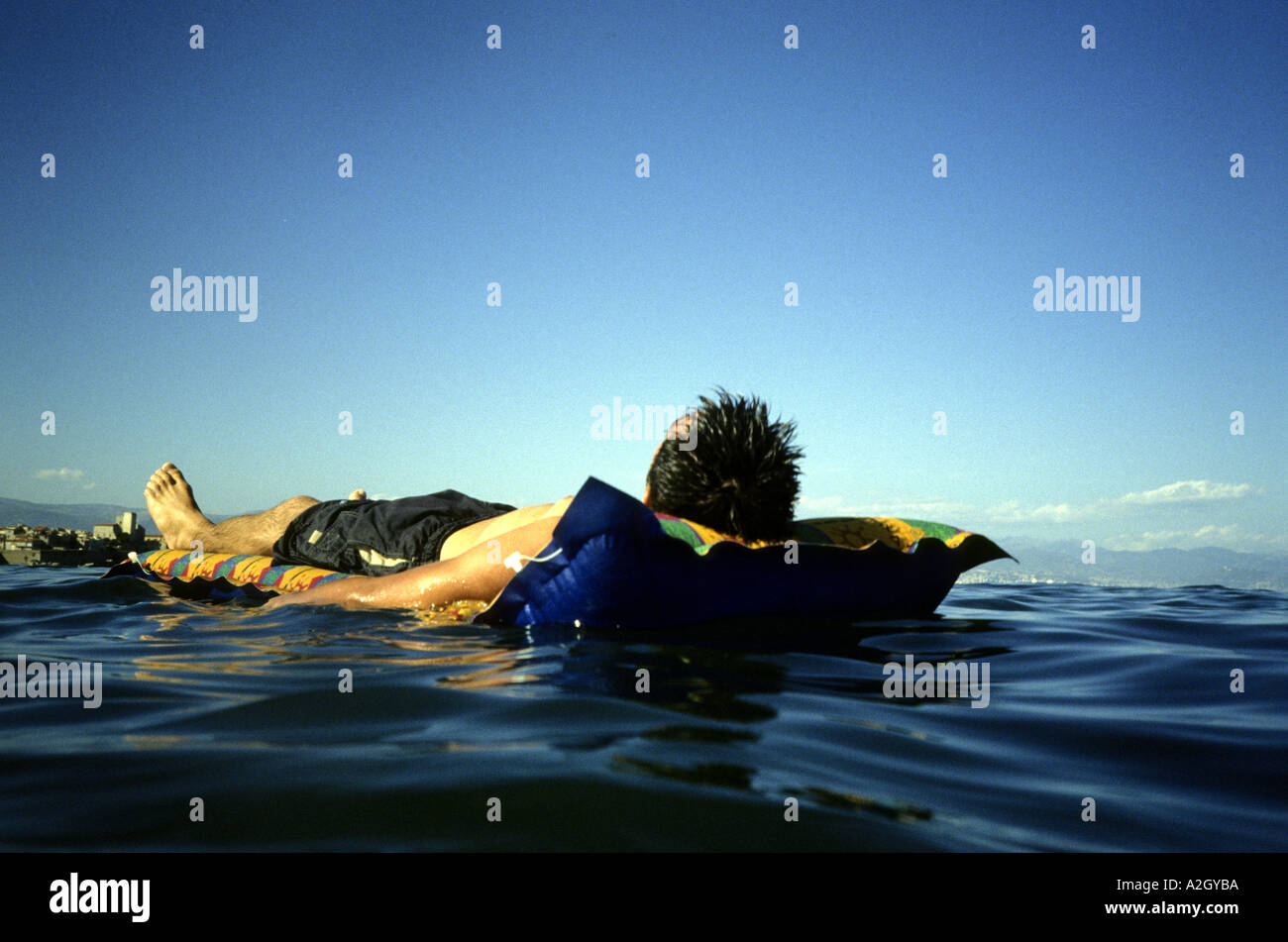 person asleep on airbed afloat off the beach Antibes France Stock Photo ...