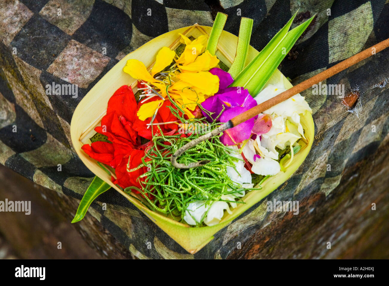 Indonesia Bali daily flower offering canang at small shrine Stock Photo ...