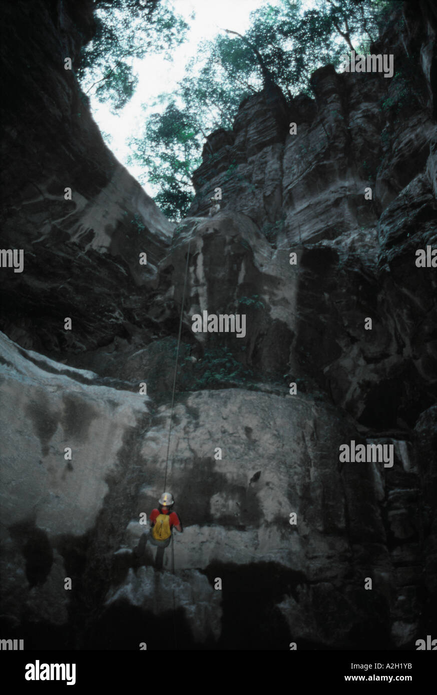 A caver uses mountaineering techniques to descend by rope into a ...