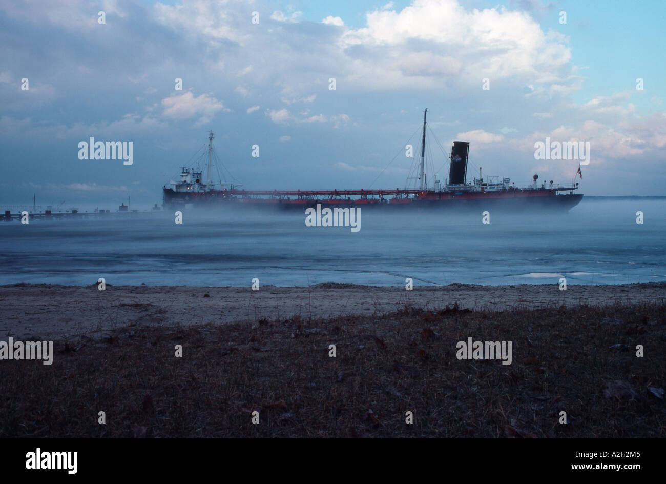 A oil tanker ship is docked at a winter Lake Michigan port Traverse ...