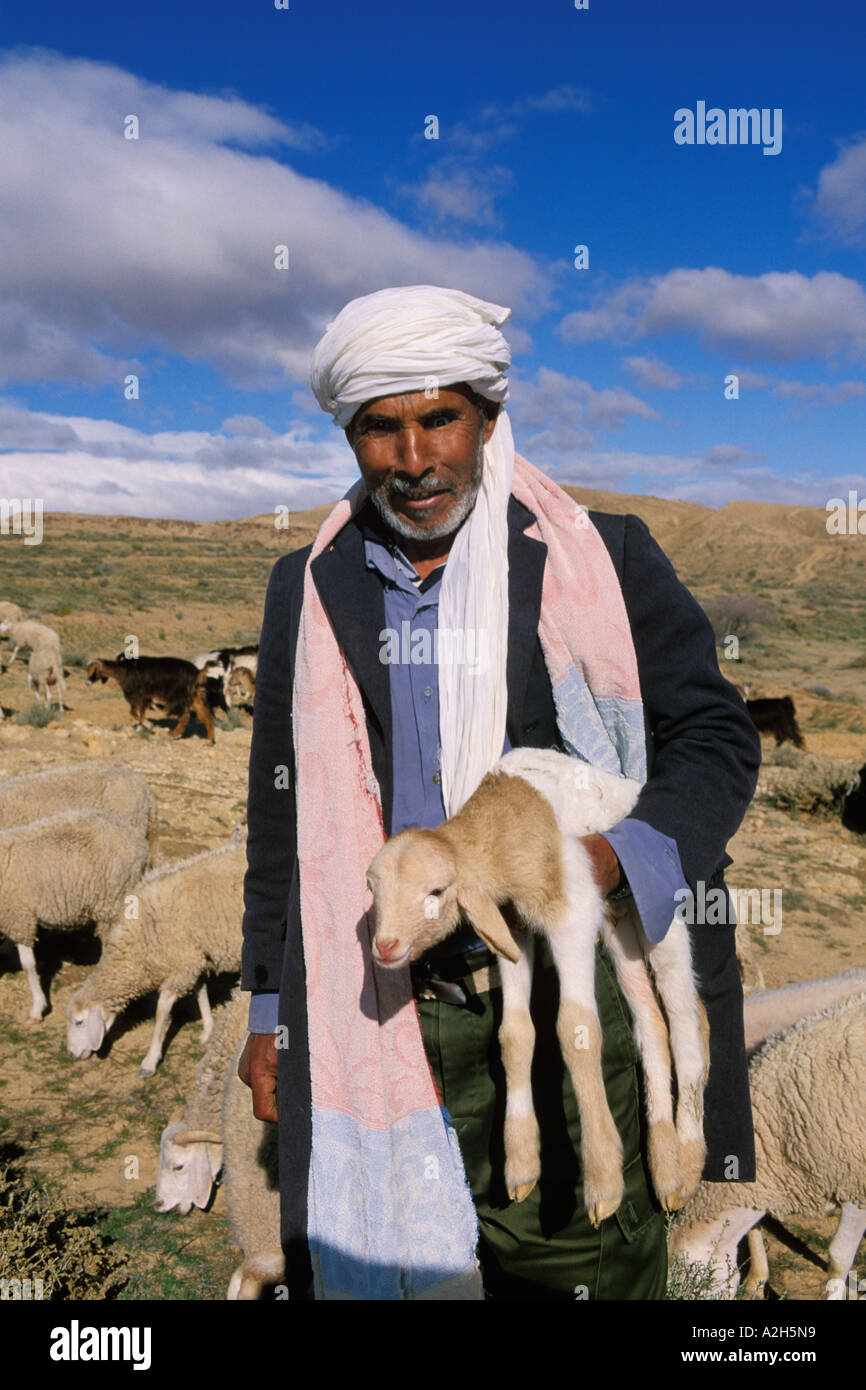 Tunisia, Shepherd holding lamb Stock Photo - Alamy