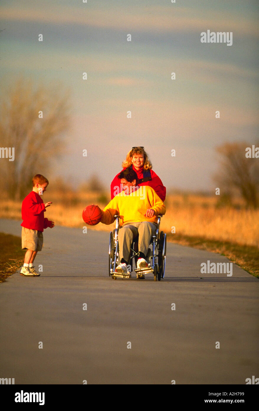 Physically challenged man with family Stock Photo - Alamy