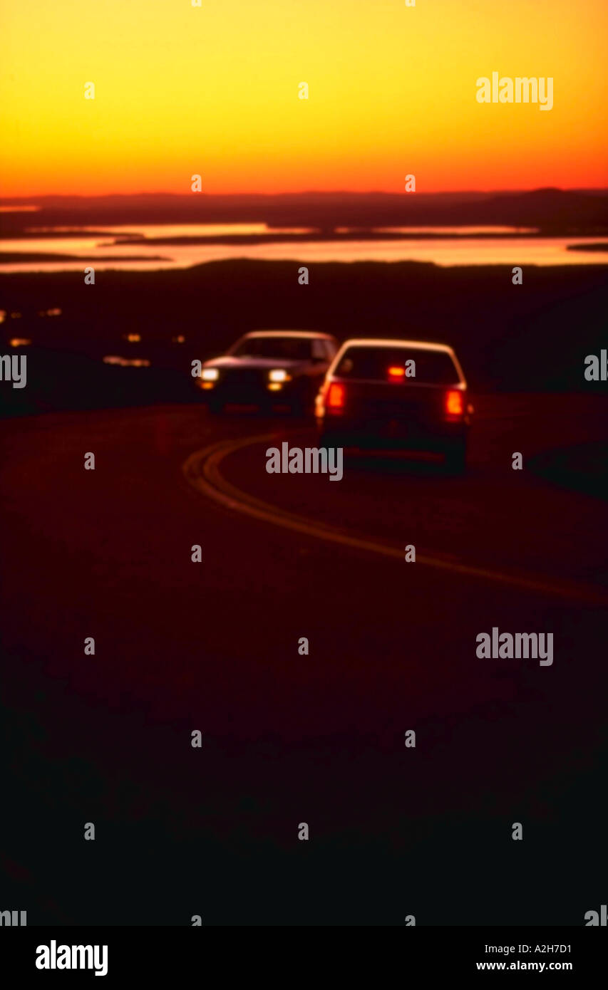Cars on road at sunset Stock Photo - Alamy