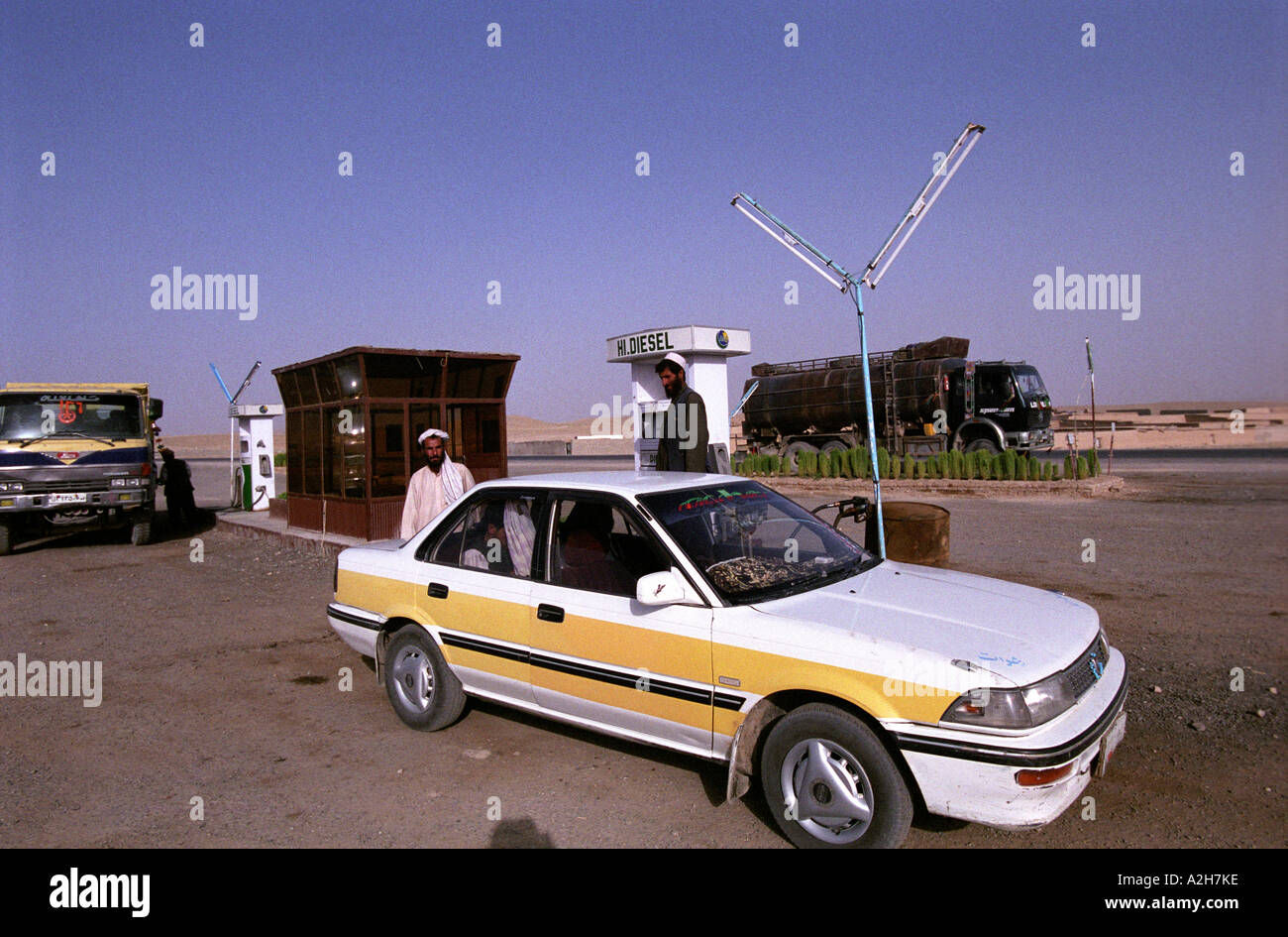 Afghanistan A taxi driver stops his car at the petrol station for fuel ...