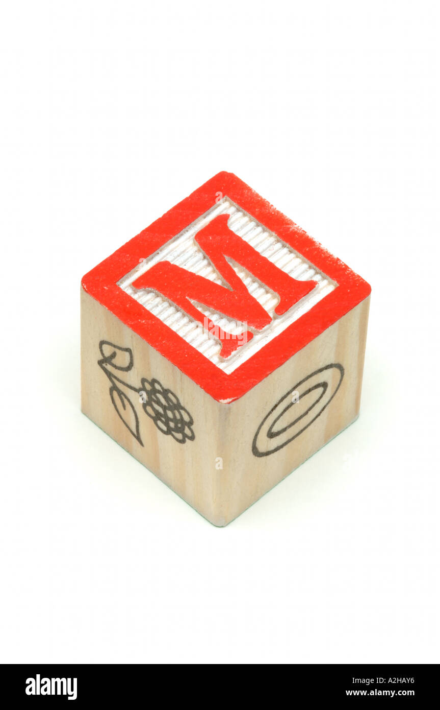 Children wooden learning block showing red alphabet M Stock Photo - Alamy