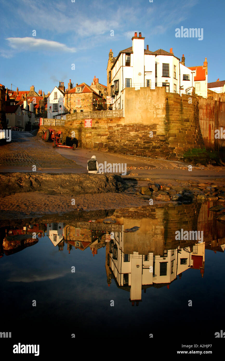 Early winters morning at Robin Hoods Bay.Reflection and warm lighting ...