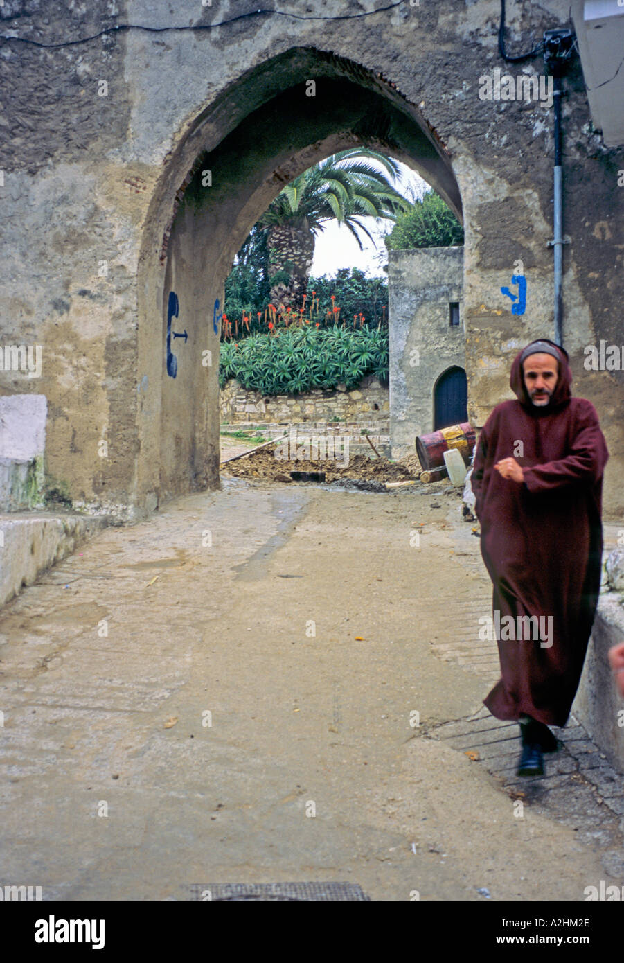 AFRICA MOROCCO TANGIER Typical street scene with view through arch into ...