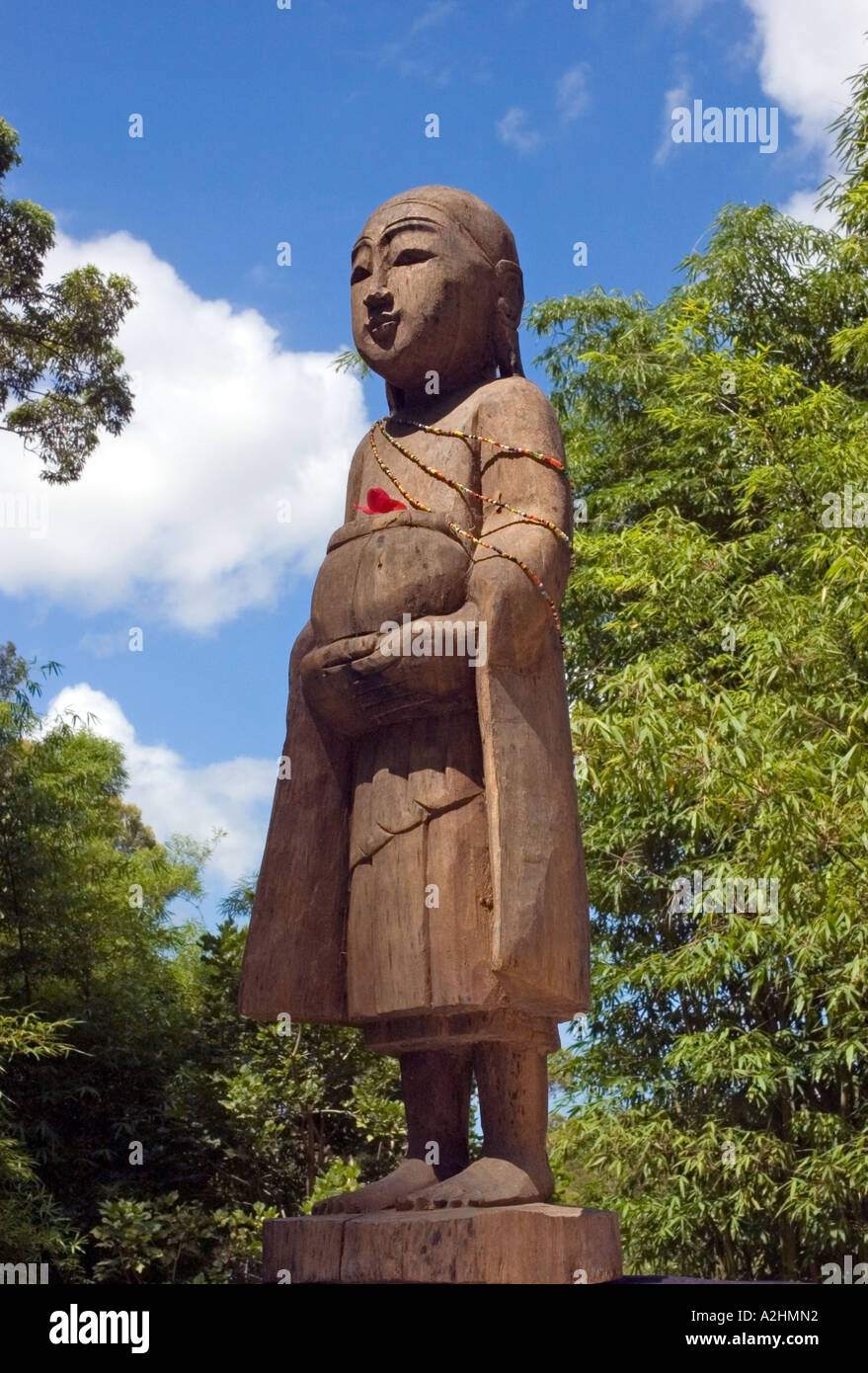 Jizo style carved wooden Buddhist statue of a monk with a begging bowl ...