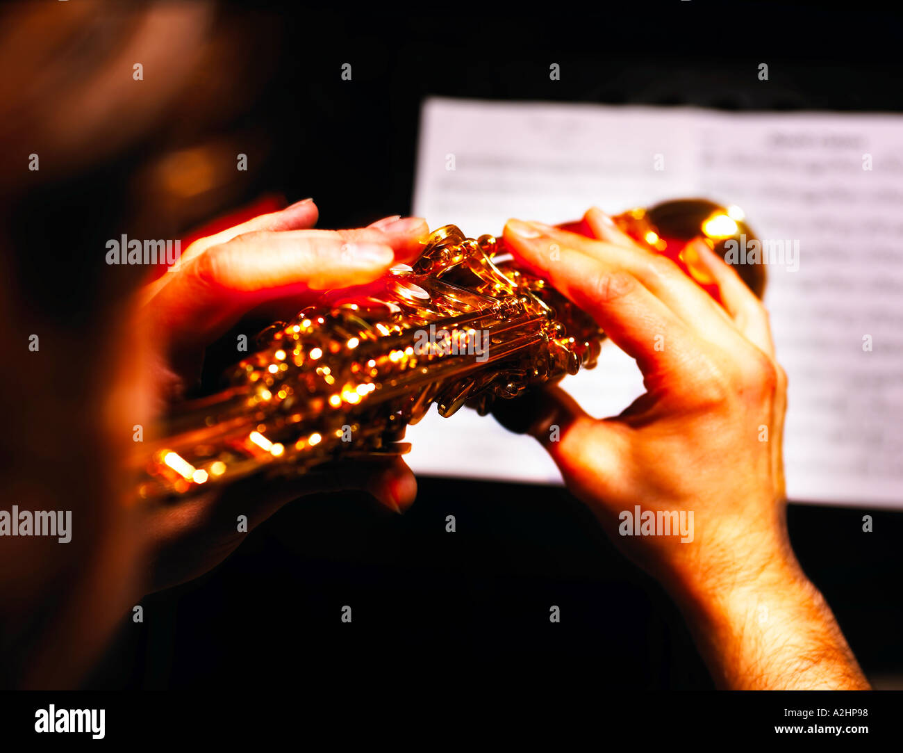 Square shot of man playing soprano on a black background with blured ...