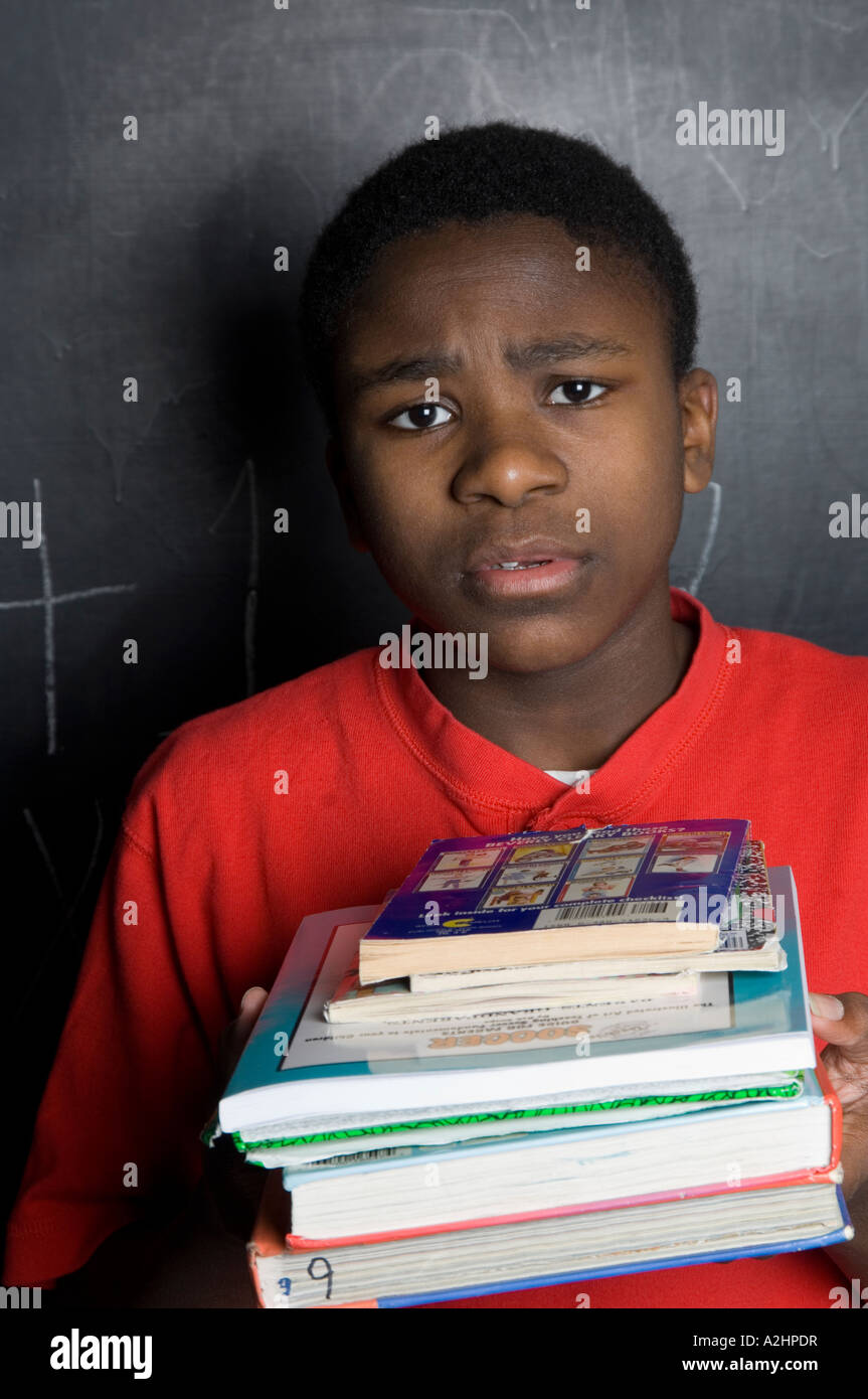 Stressed out student with books in classroom Stock Photo - Alamy