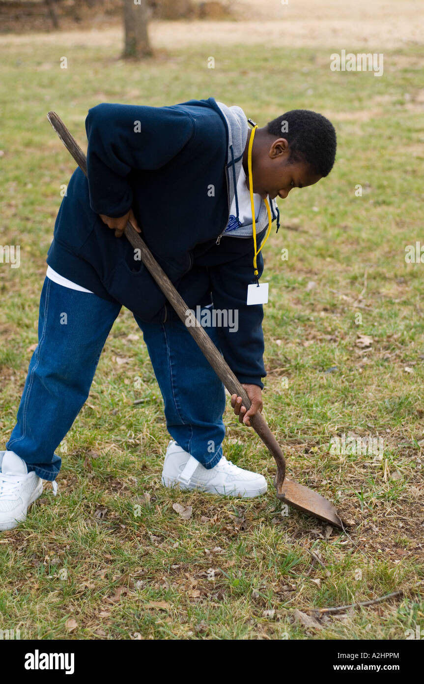 young boy digging with the shuffle Stock Photo - Alamy