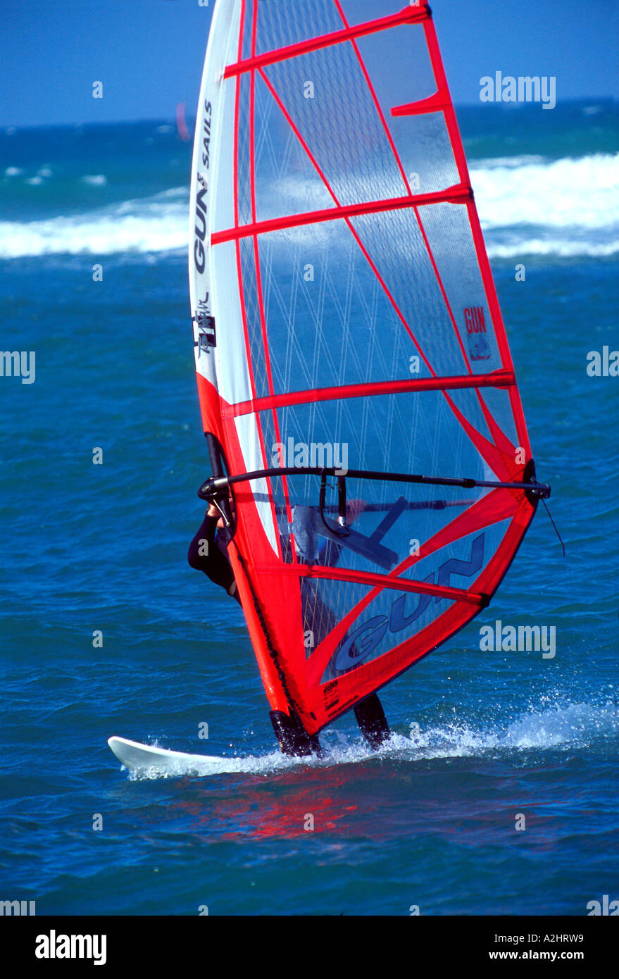 Windsurf action shot with a man and a colorful sail Stock Photo - Alamy
