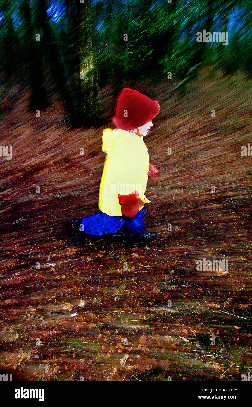 child age 3-5 running through the forest,the image exhibits motion blur ...